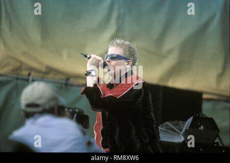 The lead singer of the Offspring is shown performing on stage during ...