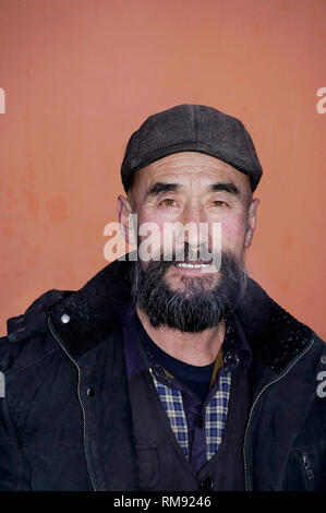 Friendly mature bearded man wearing eyeglasses and smiling while ...