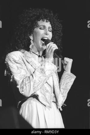 Cher, born Cherilyn Sarkisian, is shown on stage performing on stage ...