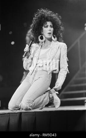 Cher, born Cherilyn Sarkisian, is shown on stage performing on stage ...