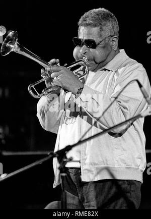American jazz musician Dizzy Gillespie puffing out his cheeks during a ...