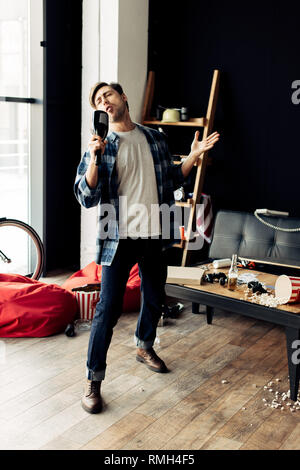 drunk man holding bottle and singing at home Stock Photo - Alamy