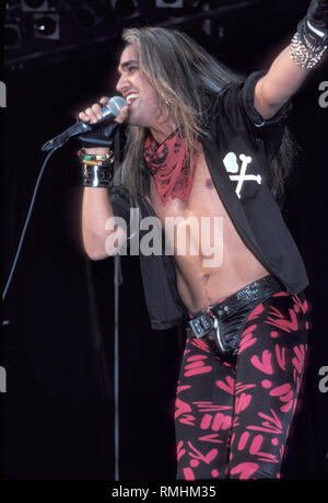 Singer Marq Torie is shown performing on stage during a concert ...