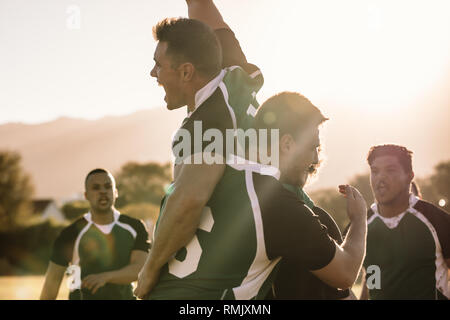 Rugby players celebrating a win Stock Photo - Alamy