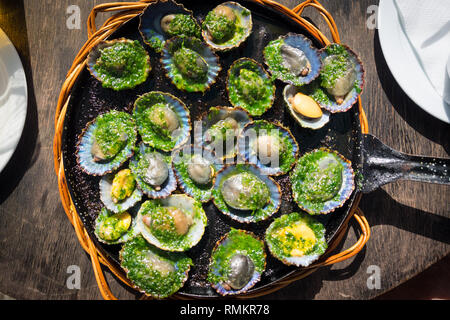 tasty seafood - grilled limpets served with lemon. Lapas grelhadas ...