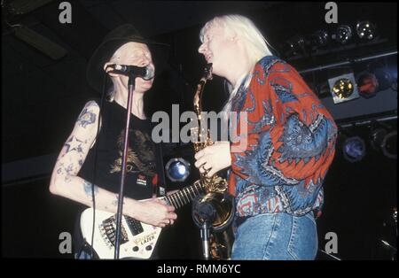 Brothers Johnny and Edgar WInter are shown performing on stage together ...