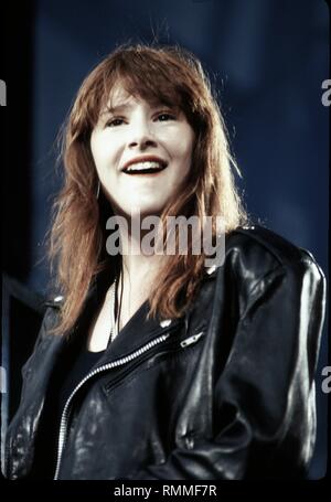 Pop singer Tiffany is shown performing on stage during a "live" concert ...
