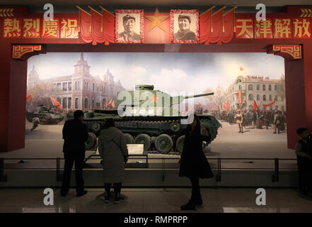 Chinese visitors look at tanks used in war on display at the Military ...