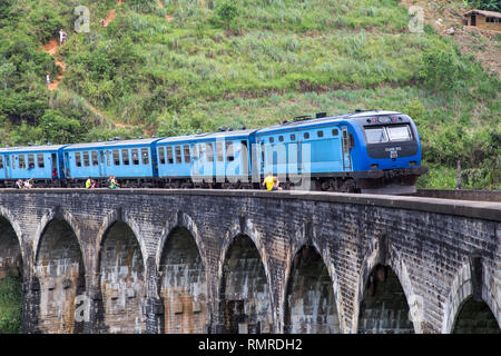 Blue train on the famous Nine Arch Bridge in the jungle on the island ...