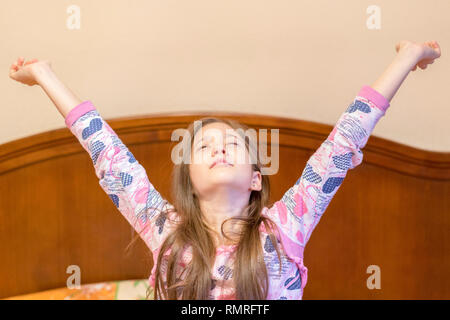 Baby girl in the morning wakes up and checks her wet diaper curiously ...