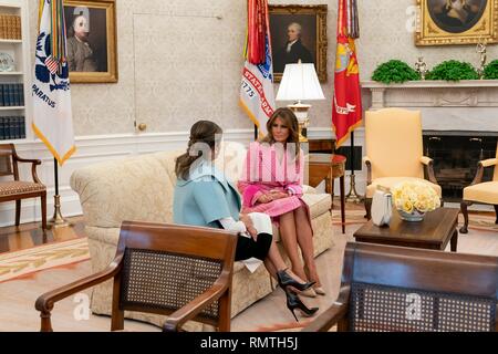 First Lady Melania Trump sits as President Donald Trump reviews the ...