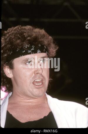 Singer Mike Reno is shown performing on stage during a "live" concert ...