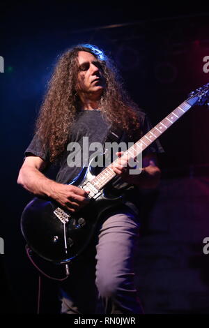 Fates Warning are shown performing on stage during a "live" concert ...