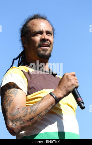 Musician Michael Franti is shown performing on stage during a "live ...