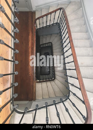 A top view of a deep, circular stone well, with ropes and cables ...