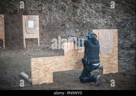Advanced outdoor tactical shooting on target around barrier and wall ...