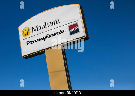 A logo sign outside of a Manheim auto auction site in Manheim ...