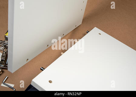 Handyman is assembling a cabinet. Furniture put together concept Stock ...