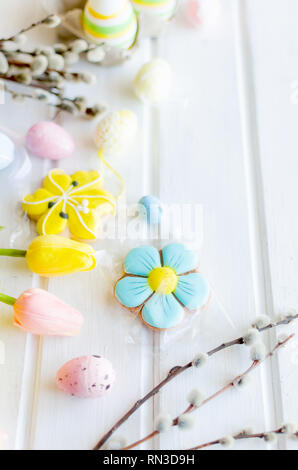 yellow tulips, ginger cookies, willow twigs, decorative eggs in a tray ...