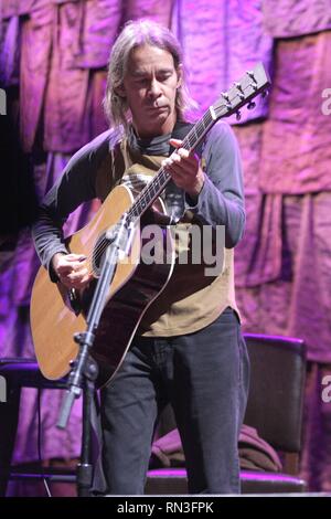 Guitarist Tim Reynolds is shown performing on stage during a concert ...