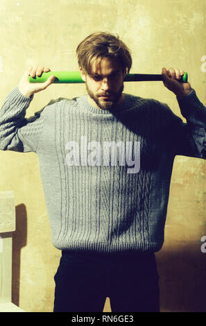 Energetic man holding a bat behind his head and emotions light ...