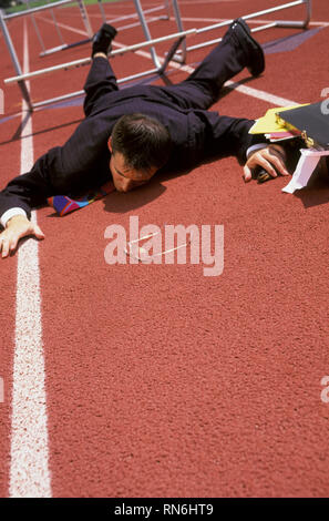 Young businessman fallen over hurdle on running track, USA Stock Photo ...