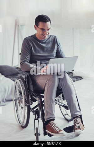 Funny man in wheelchair on white background Stock Photo - Alamy