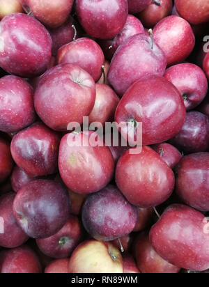 Red apples on red satin fabric, background Stock Photo - Alamy