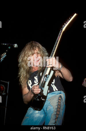 Danger Danger guitarist is shown performing on stage during a "live ...