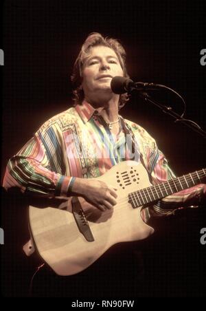 Singer-songwriter John Denver is shown performing on stage during a ...