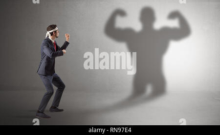 Businessman fighting with his bossy yelling shadow Stock Photo - Alamy