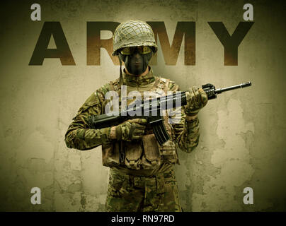 Uniformed armed soldier with damaged wall background Stock Photo - Alamy