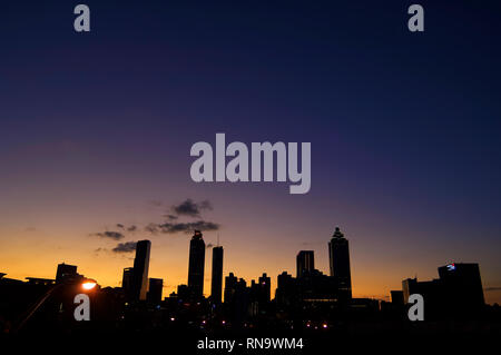 A dramatic sunset over several modern high-rise buildings in Atlanta ...