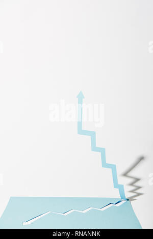 Arrow and sheet of paper with copy space isolated on red background ...