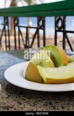 Melon slice cuted close up on a white background Stock Photo - Alamy