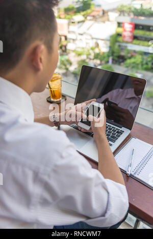 Vertical photo of man using smartphone Stock Photo - Alamy