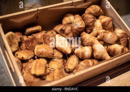 Croissants on a wooden box weave in a bakery shop or hotel Stock Photo ...