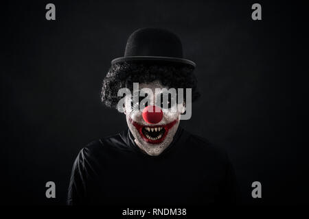 Scary clown showing his sharp pointy teeth Stock Photo - Alamy
