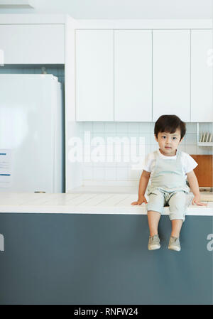 Little boy sitting on kitchen stool Stock Photo: 39466109 - Alamy