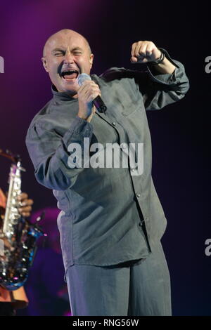 Musician Phil Collins is shown performing on stage during a "live ...