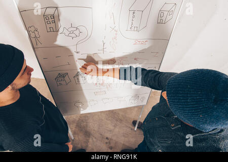 Dangerous thiefs standing in a room and making a plan for heist Stock ...