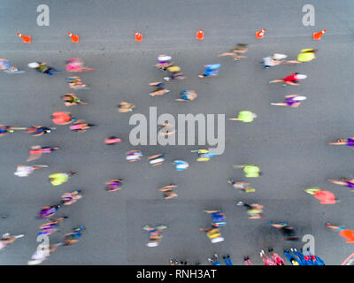 Aerial View of Marathon Runners on a Bridge Crossing a River. A city ...