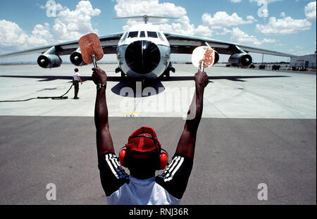 1981 - A1C Kevin D. Bailey marshalls a C-141 Starlifter aircraft into a ...