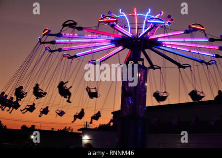 Spinning Swings at Amusement Park Stock Photo - Alamy