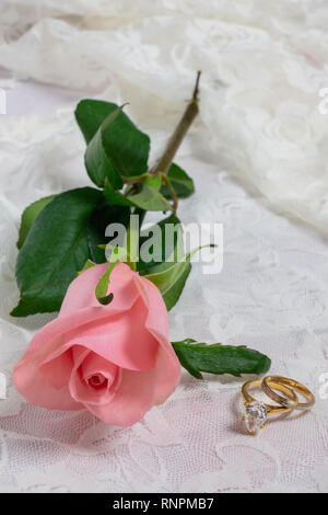 Wedding Band on Pink Flower Stock Photo - Alamy