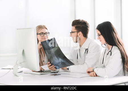 doctors experts discuss x-ray,sitting at the table .photo with copy ...