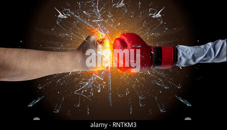 Two hands fighting and breaking glass into small pieces with fire and ...