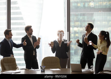 Excited african and caucasian employees dancing in office, staff party ...