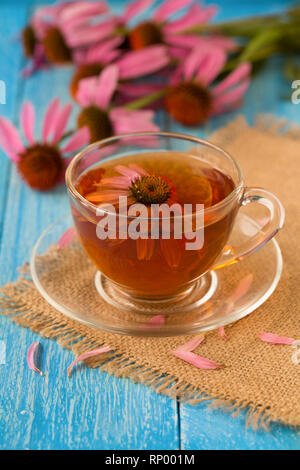 Cup of echinacea tea on blue wooden table Stock Photo - Alamy