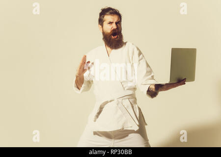 Karate man with angry face in uniform. Man with beard in white kimono ...